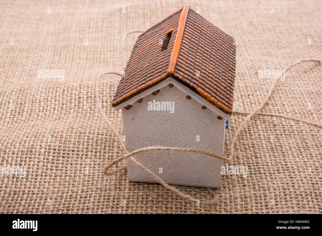Thread wrapped around a model house on a brown background Stock Photo ...