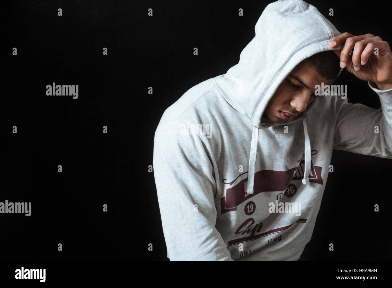 Sad disappointed african american young man in hoodie standing and ...