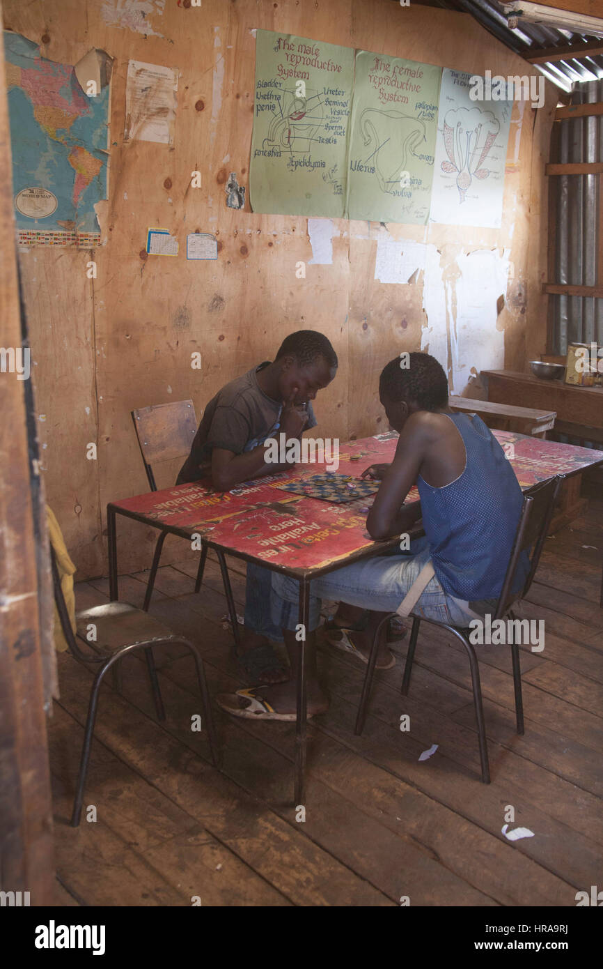 Two boys play chequers cat an orphanage in Kibera slums, Nairobi, East ...