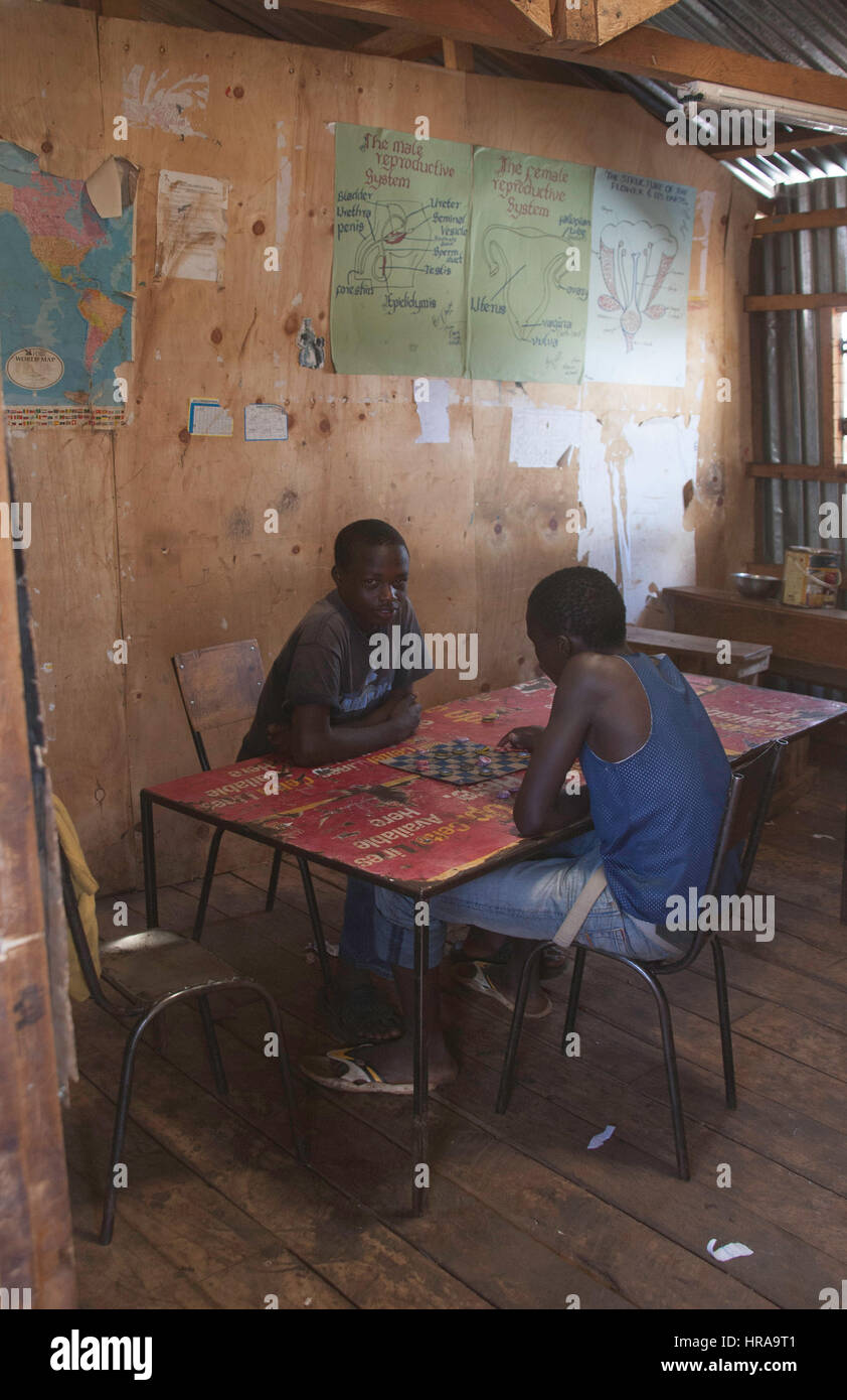 Two boys play chequers cat an orphanage in Kibera slums, Nairobi, East ...