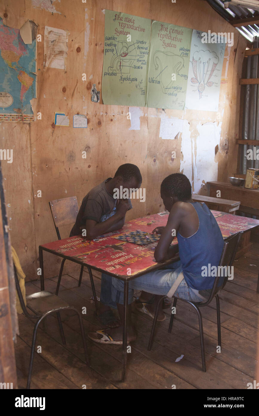 Two boys play chequers cat an orphanage in Kibera slums, Nairobi, East ...