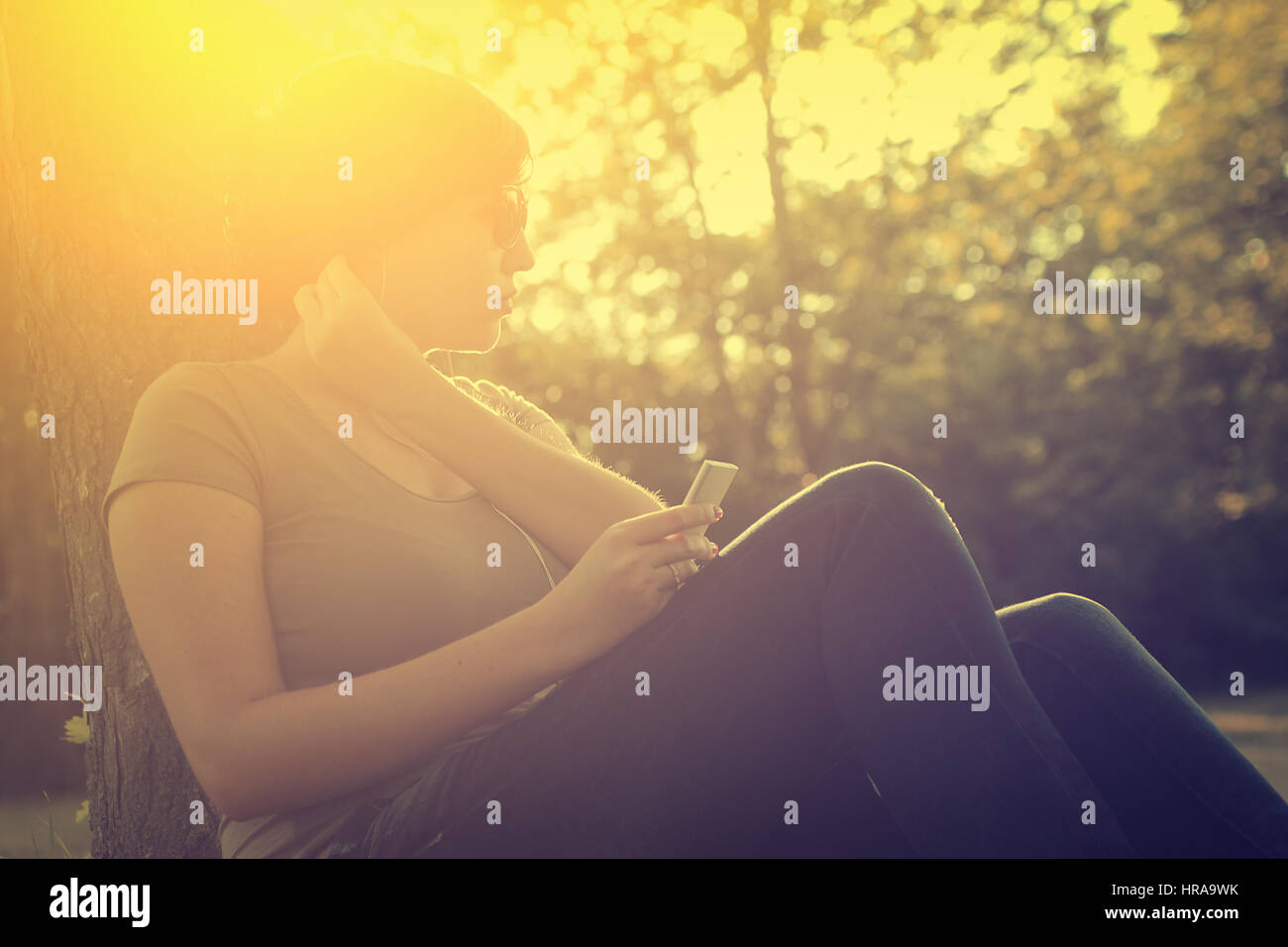 Relaxing woman in sunset Stock Photo - Alamy