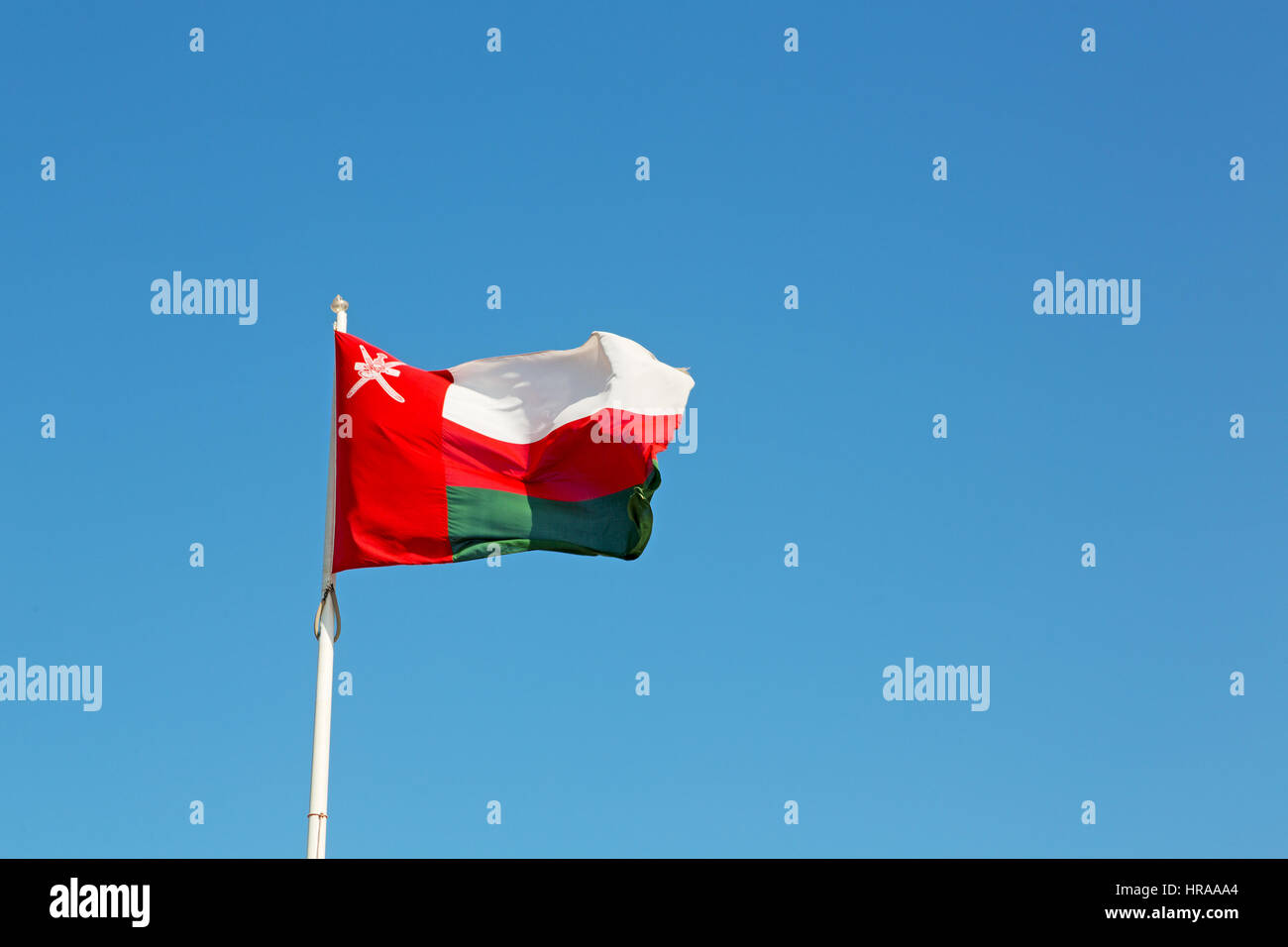 and the cloudy sky in oman waving flag Stock Photo - Alamy