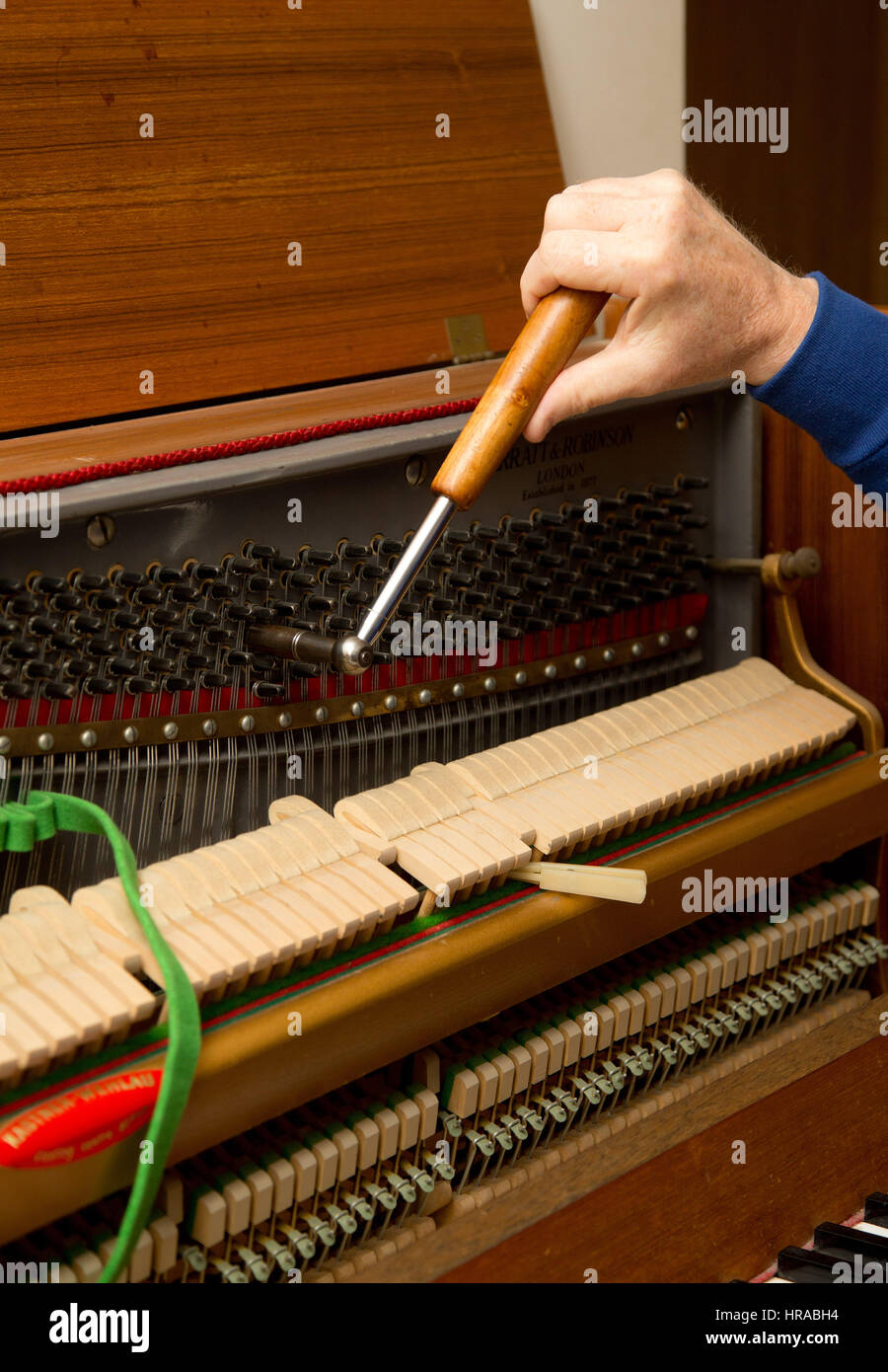 A piano tuner tuning an upright piano, London, UK Stock Photo - Alamy