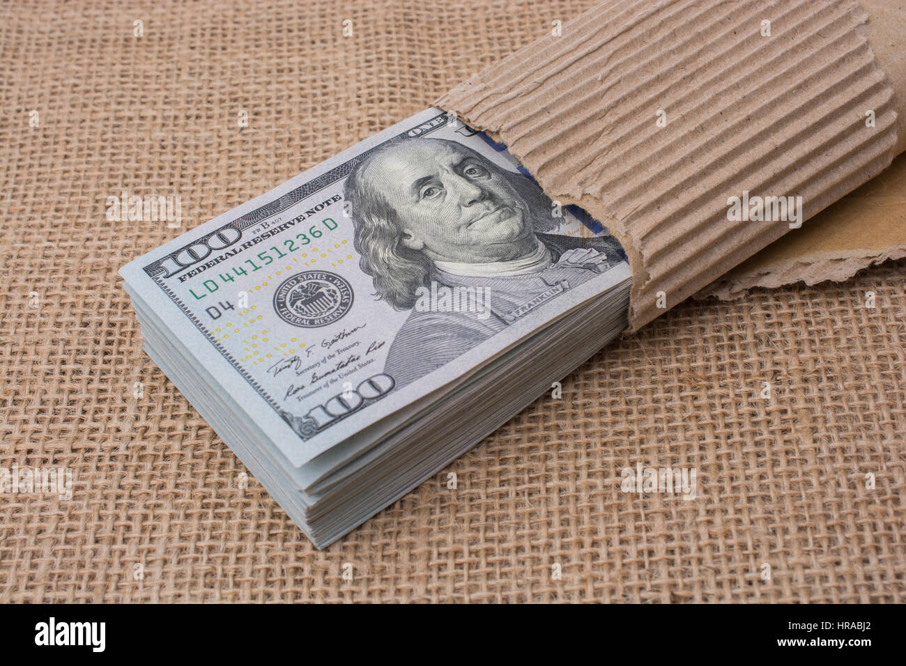 Banknote bundle of US dollar partly wrapped in cardboard Stock Photo ...