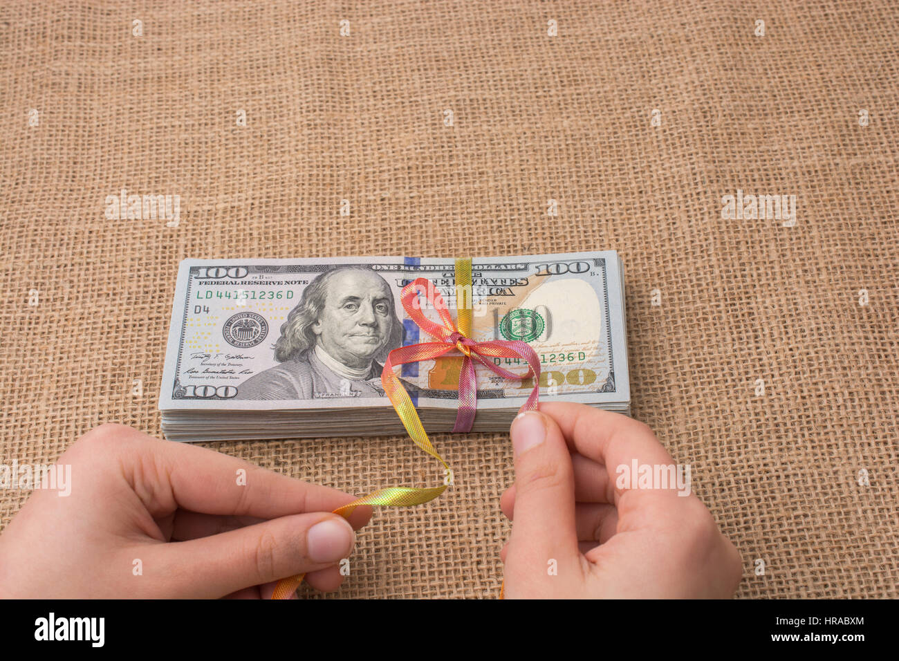 Banknote bundle of US dollar tied with colorful a ribbon Stock Photo ...