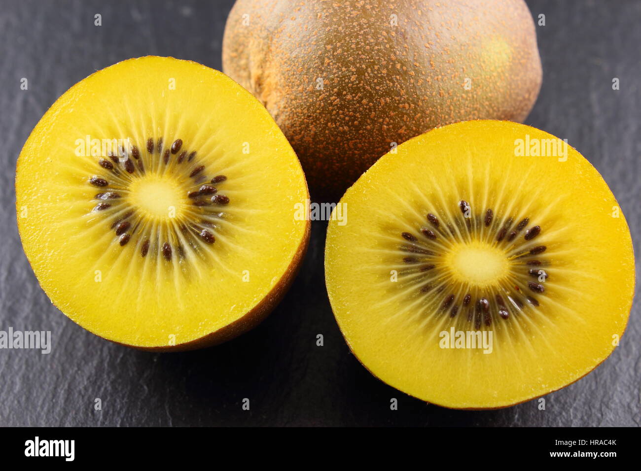 composition of fresh yellow kiwi fruits on a slate plate Stock Photo ...