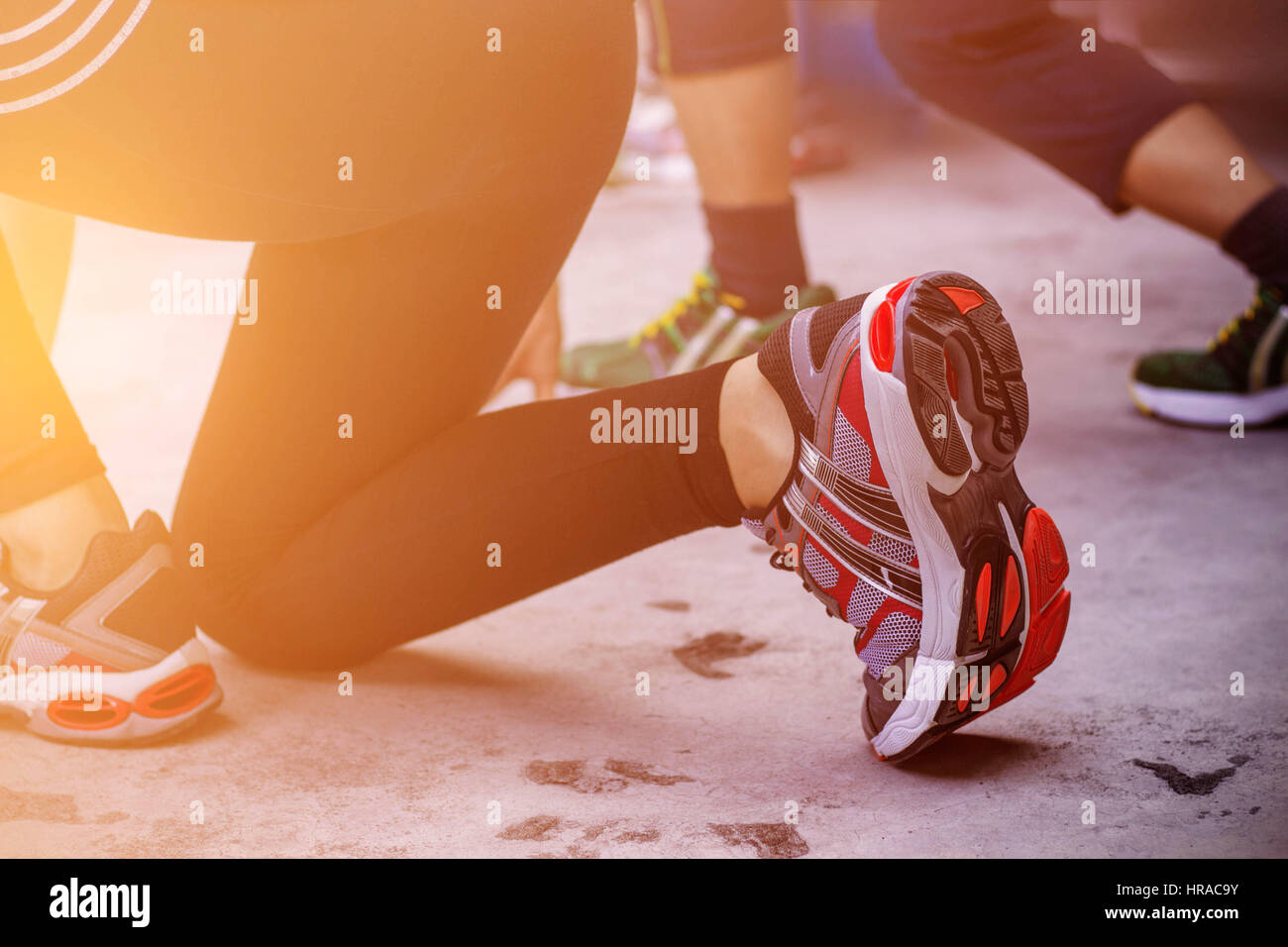 Runners preparing for a run on the stadium floor Stock Photo - Alamy