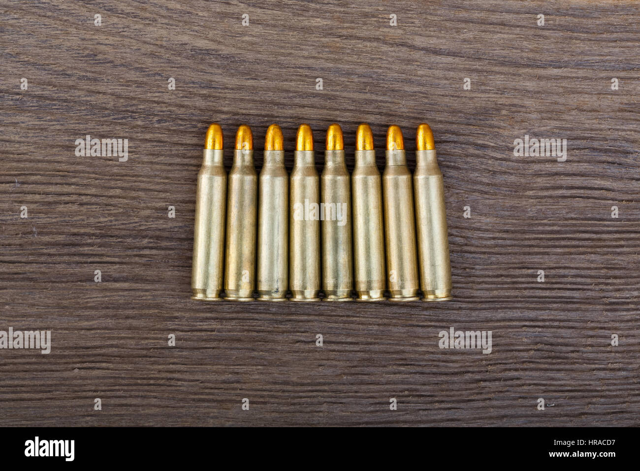 Rifle bullets on wood table Stock Photo - Alamy