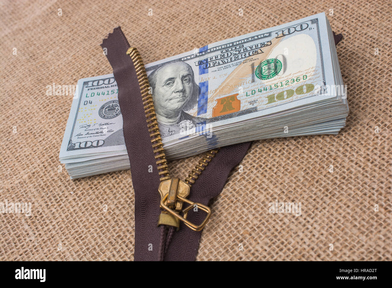 Banknote bundle of US dollar and a brown zipper Stock Photo - Alamy