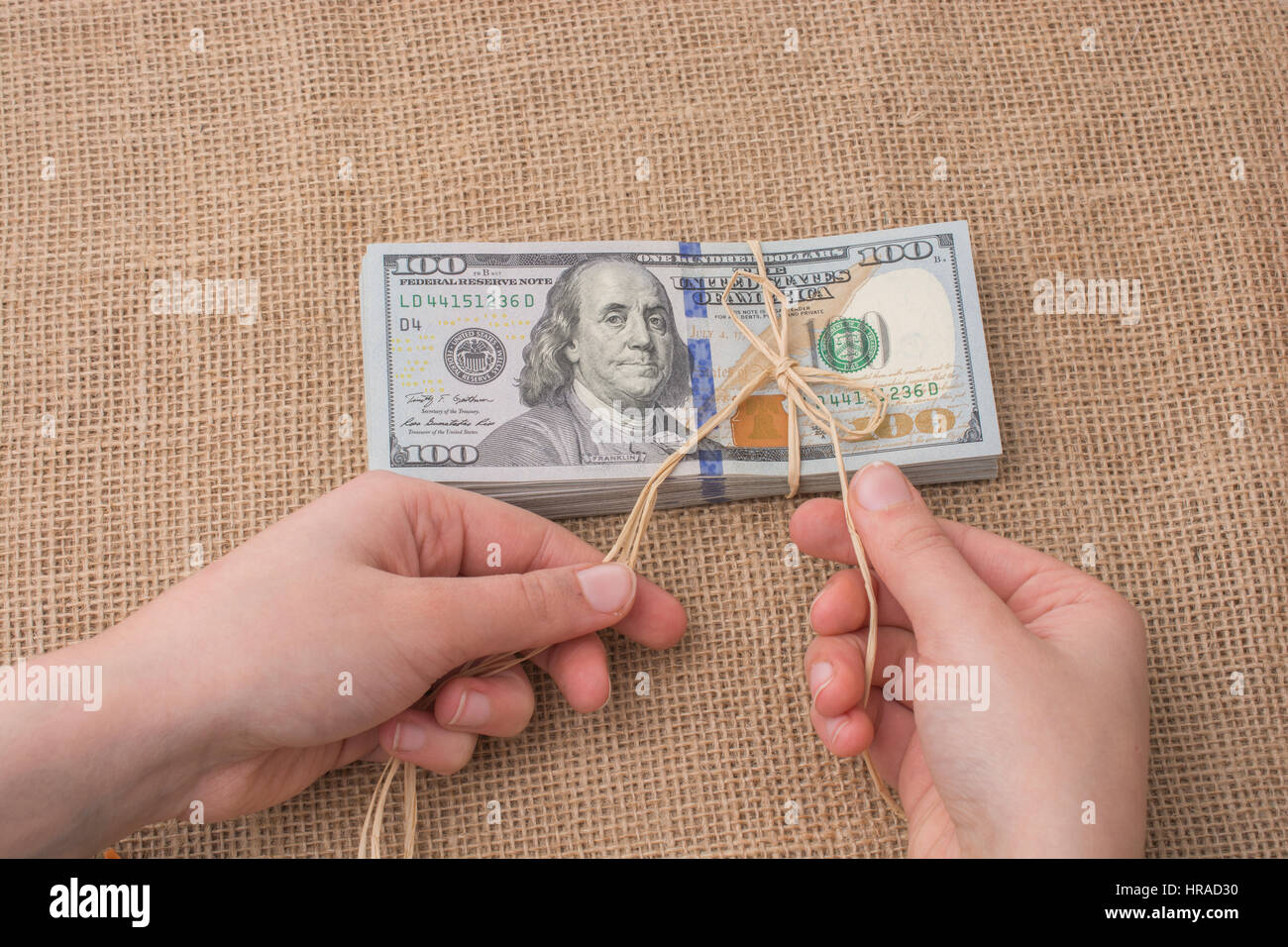 Banknote bundle of US dollar tied with colorful a ribbon Stock Photo ...