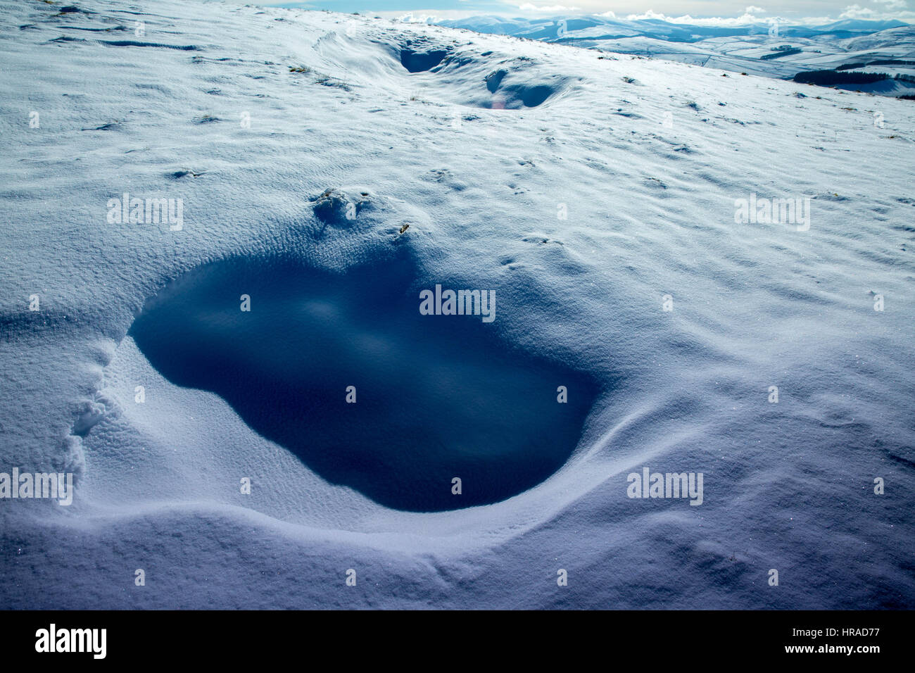 Snow blown hole Stock Photo - Alamy