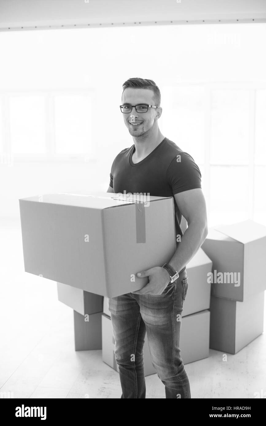 Happy man unpacking boxes Black and White Stock Photos & Images - Alamy