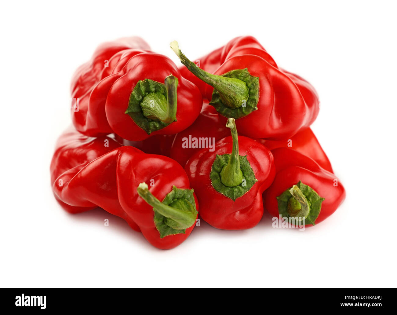 Group of five whole fresh red sweet paprika peppers isolated on white ...