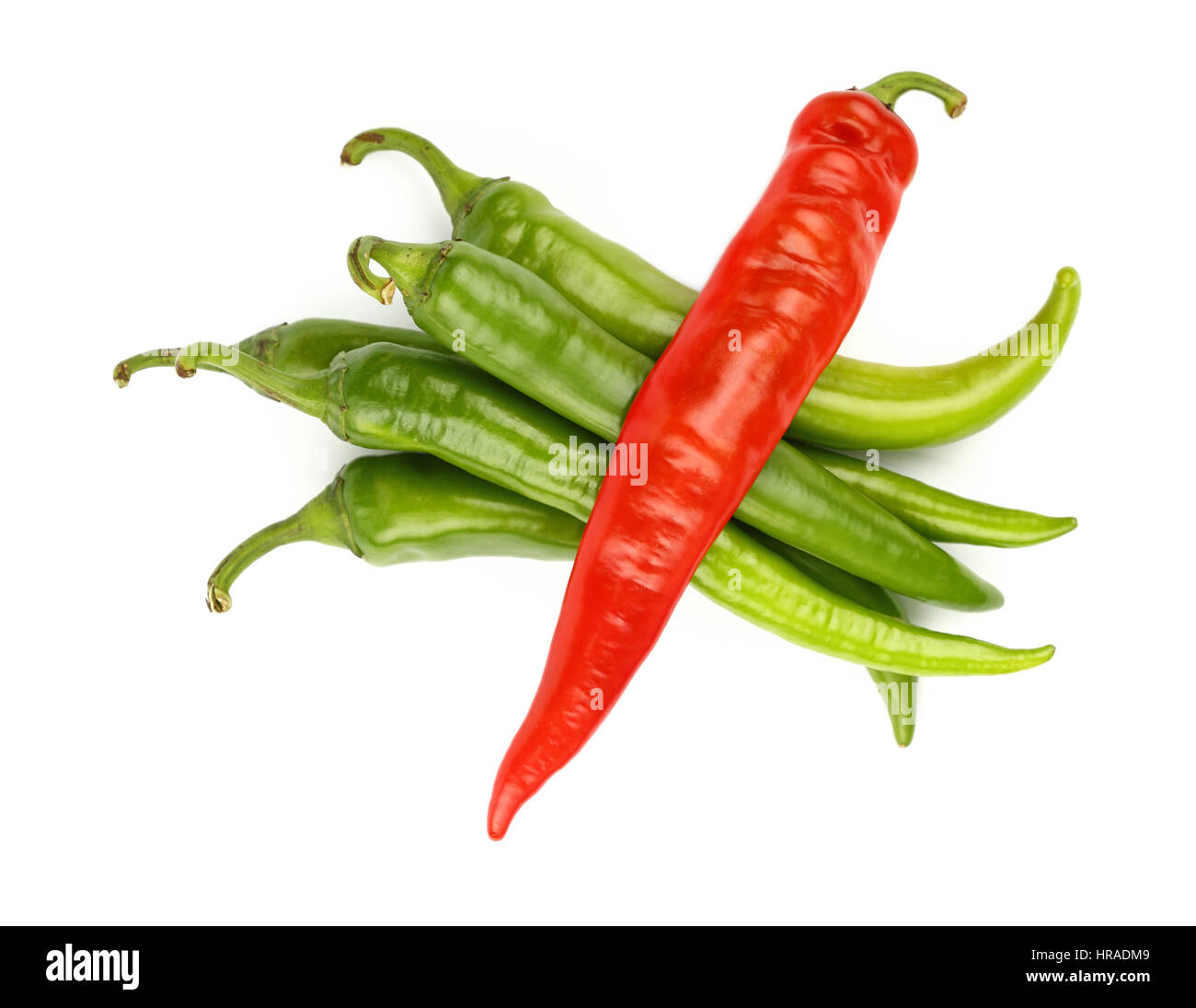 Group of fresh green jalapeno chili peppers and one red crossing above ...