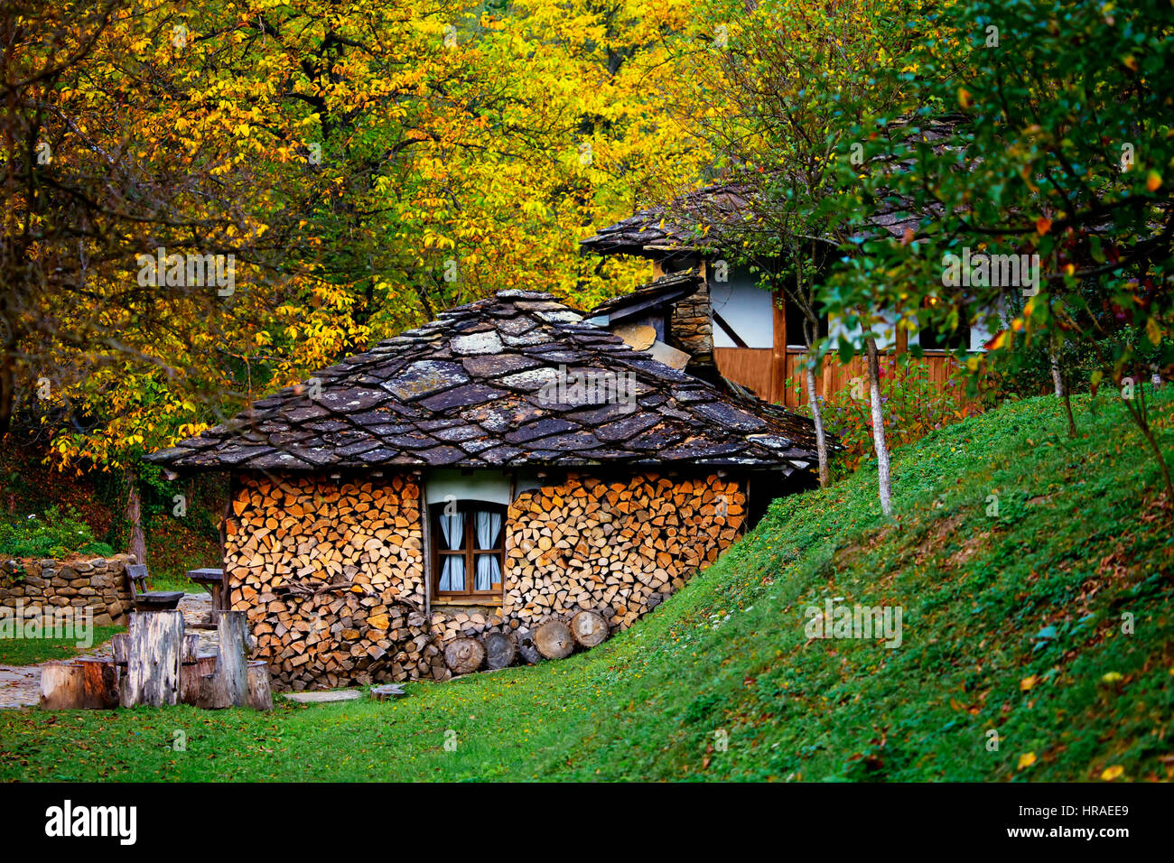 magical autumn landscape with old small houses covered with stone ...
