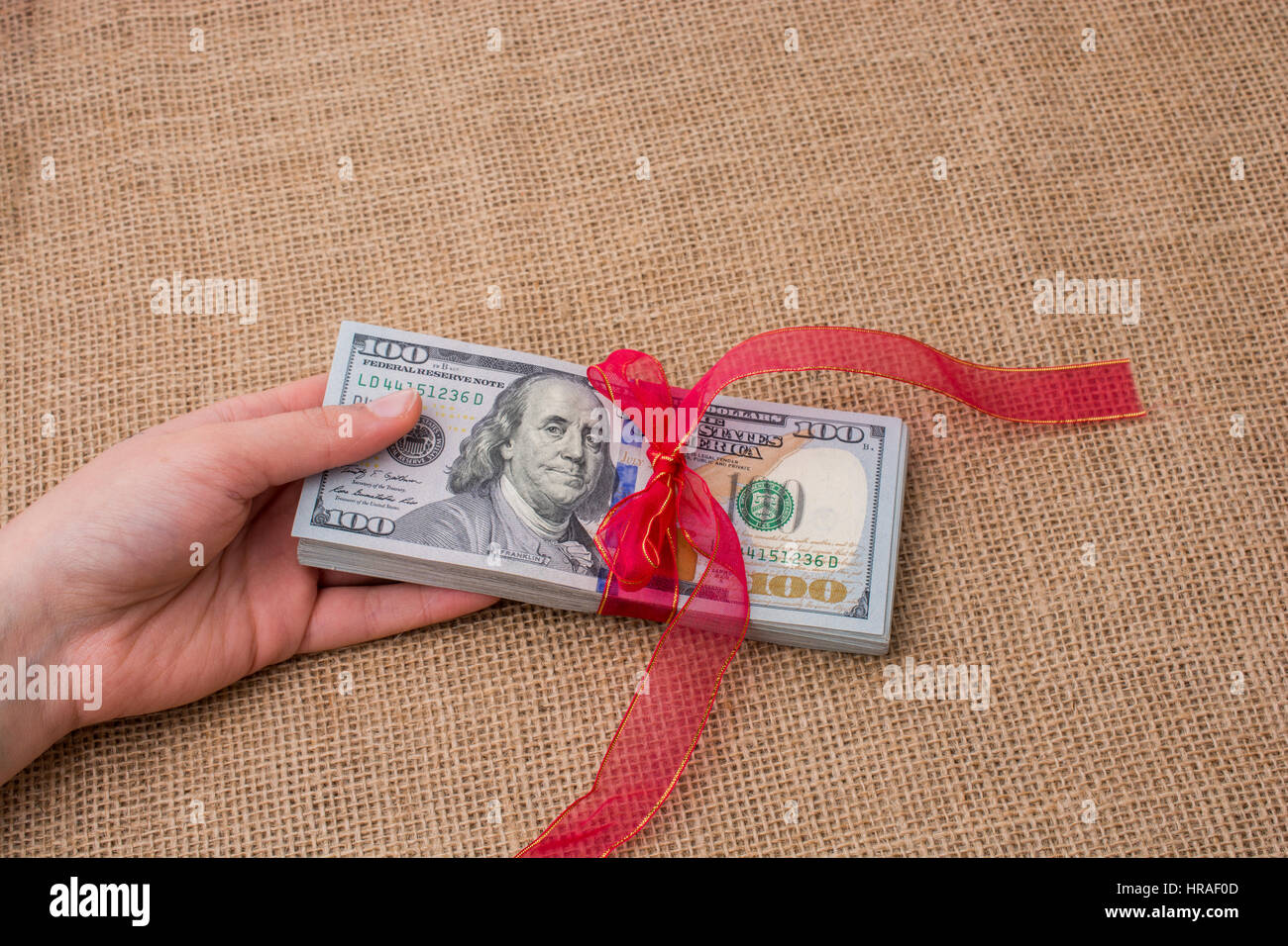 Banknote bundle of US dollar tied with colorful a ribbon Stock Photo ...