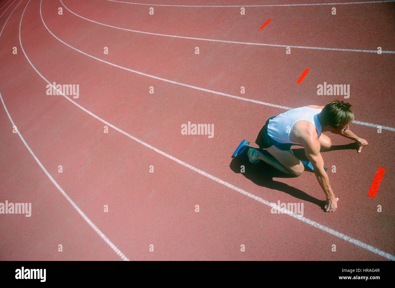 sprinter at starting line on a track Stock Photo - Alamy