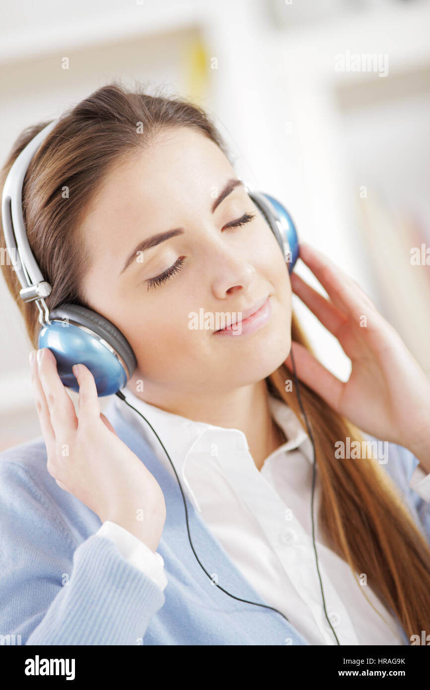 Woman wearing headphones, listening to music Stock Photo - Alamy