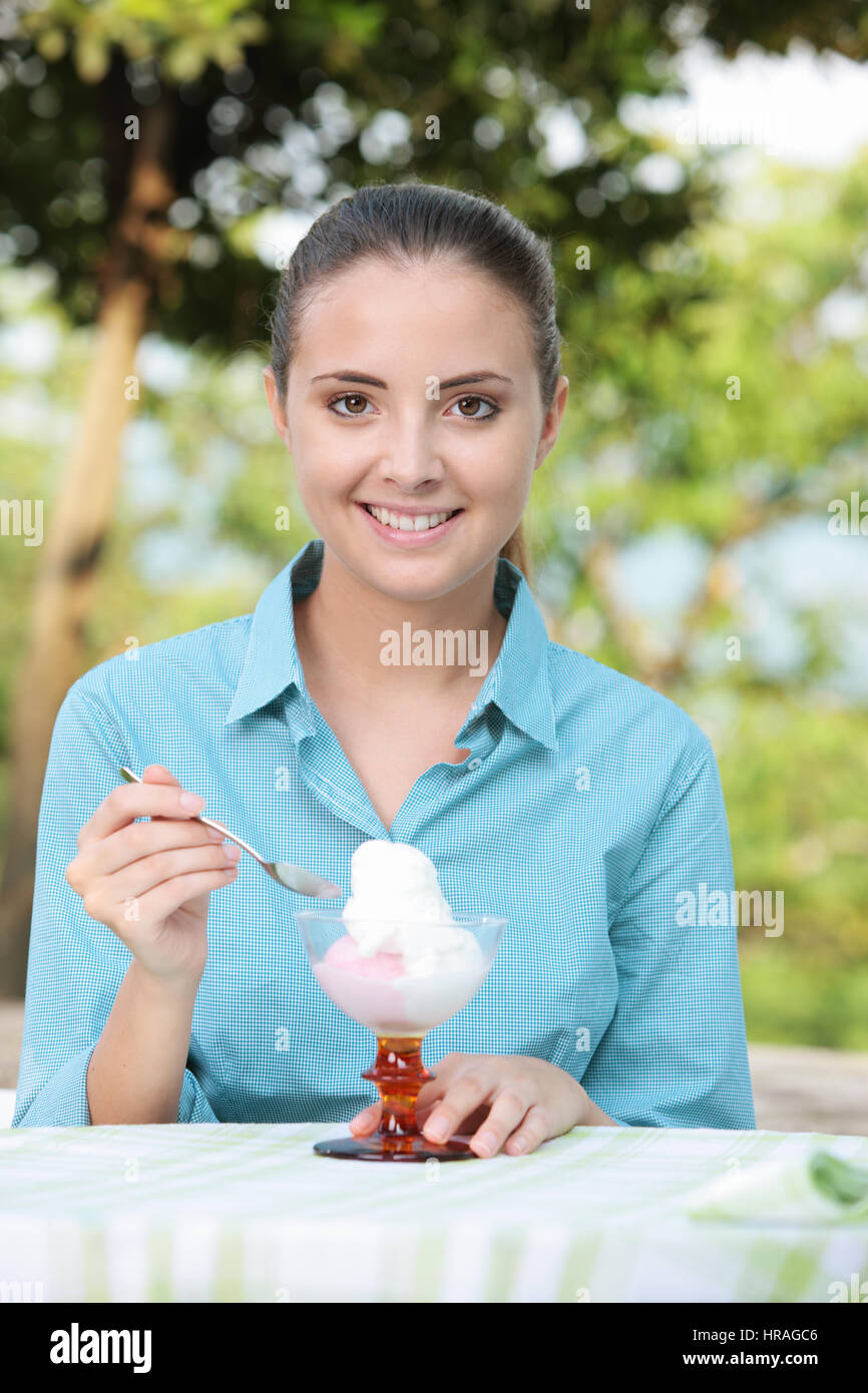 A beautiful girl eating an ice cream sundae Stock Photo - Alamy