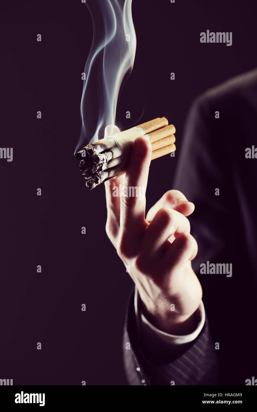 Cropped view of young man smoking many cigarettes Stock Photo - Alamy