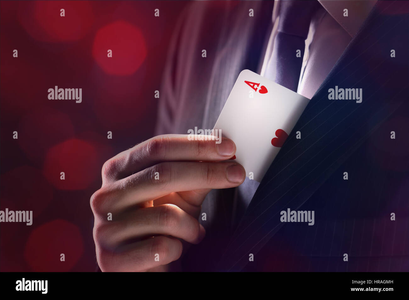 The Magician with ace card hidden under the jacket Stock Photo - Alamy