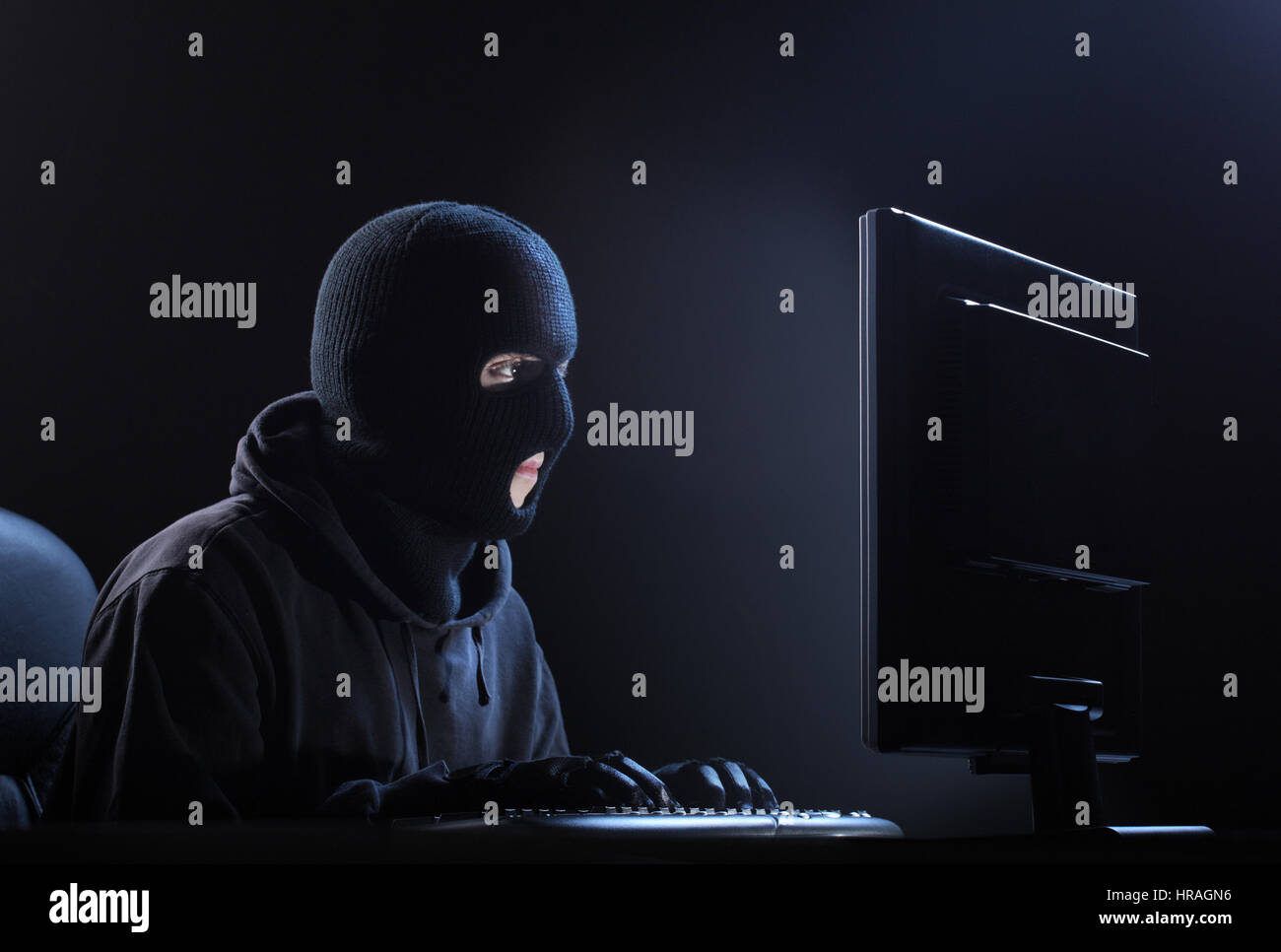 Computer hacker - Male thief stealing data from computer Stock Photo ...