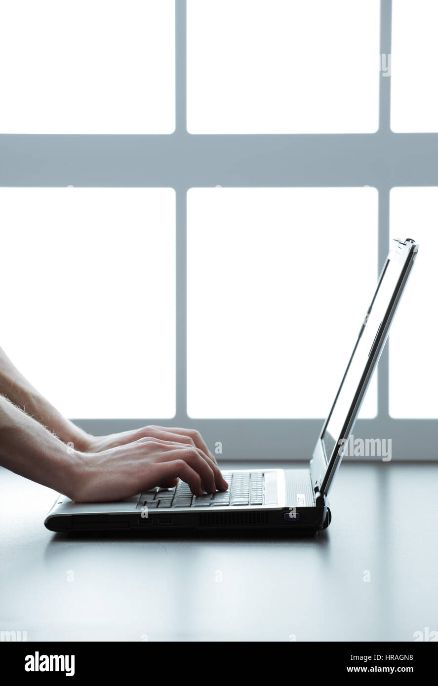 Human hands typing on a laptop Stock Photo - Alamy
