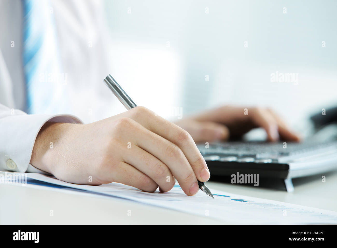 Close up image of businessman writing at workplace Stock Photo - Alamy