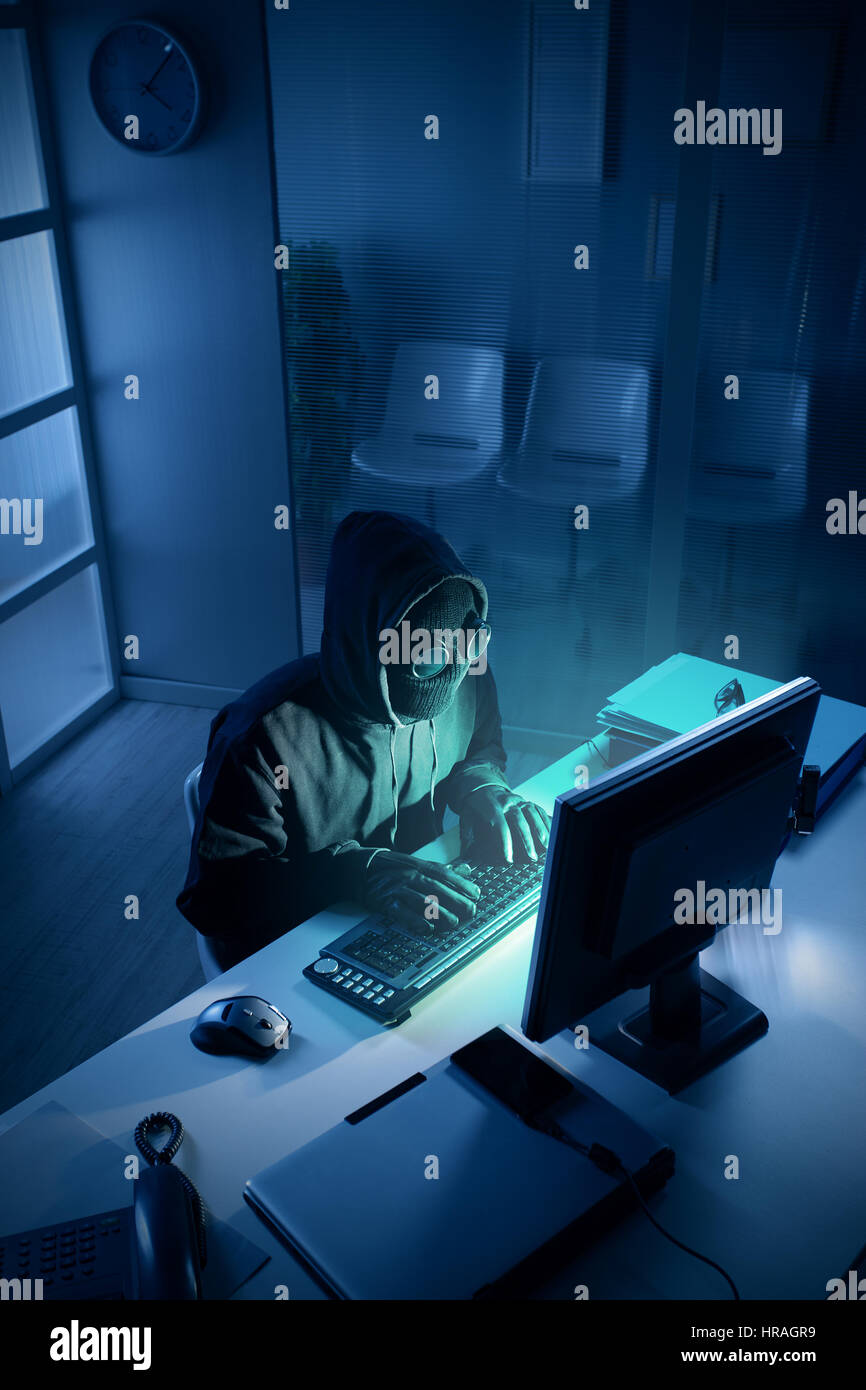 Young male thief stealing data from computer Stock Photo - Alamy