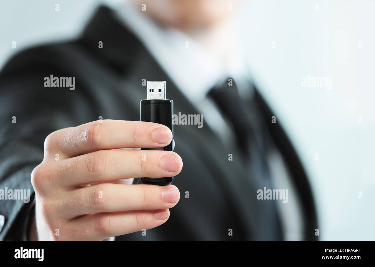 Businessman holds a USB key, close up Stock Photo - Alamy
