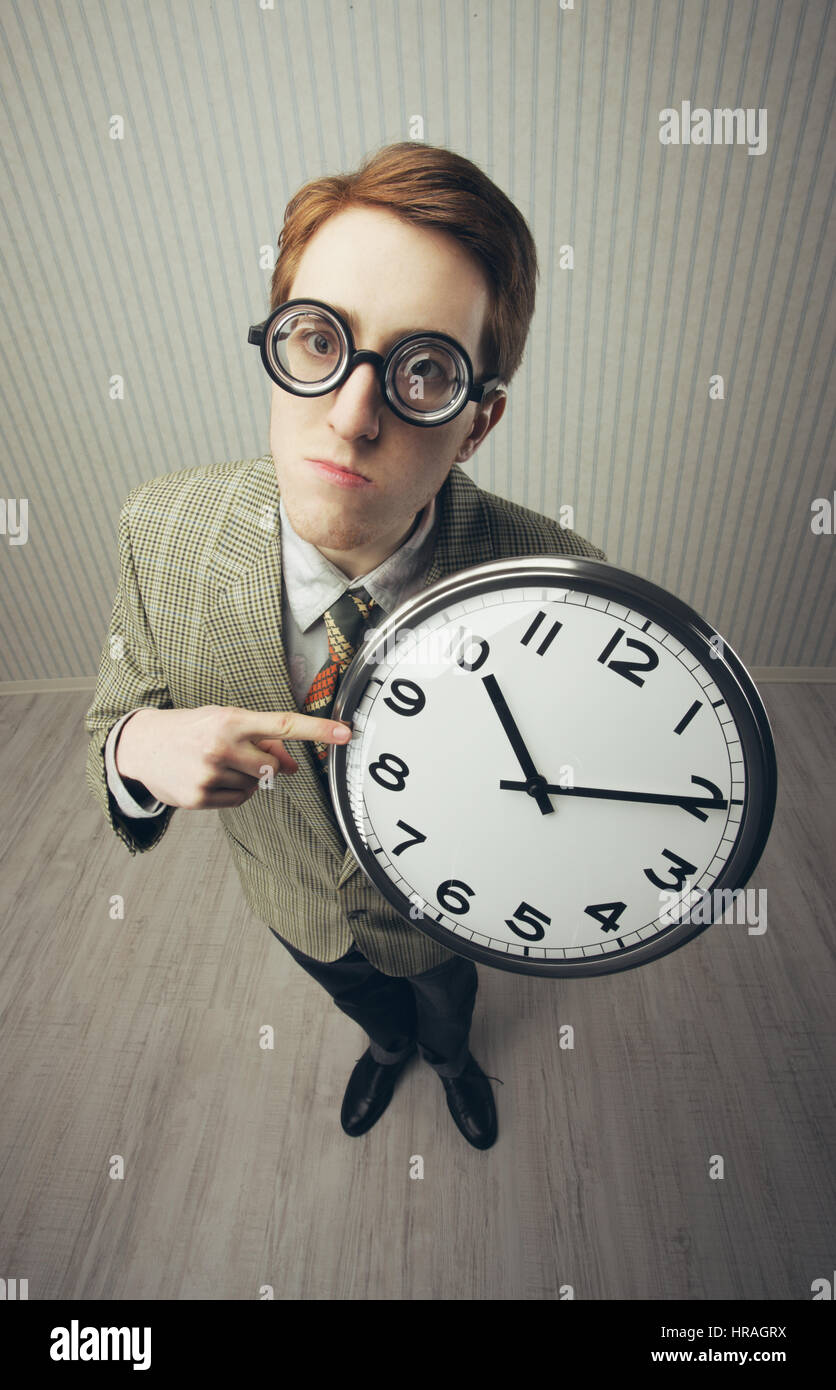 A nerdy guy with a giant-sized clock Stock Photo - Alamy
