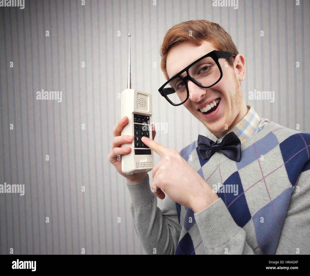 Nerd student with an old mobile phone Stock Photo - Alamy