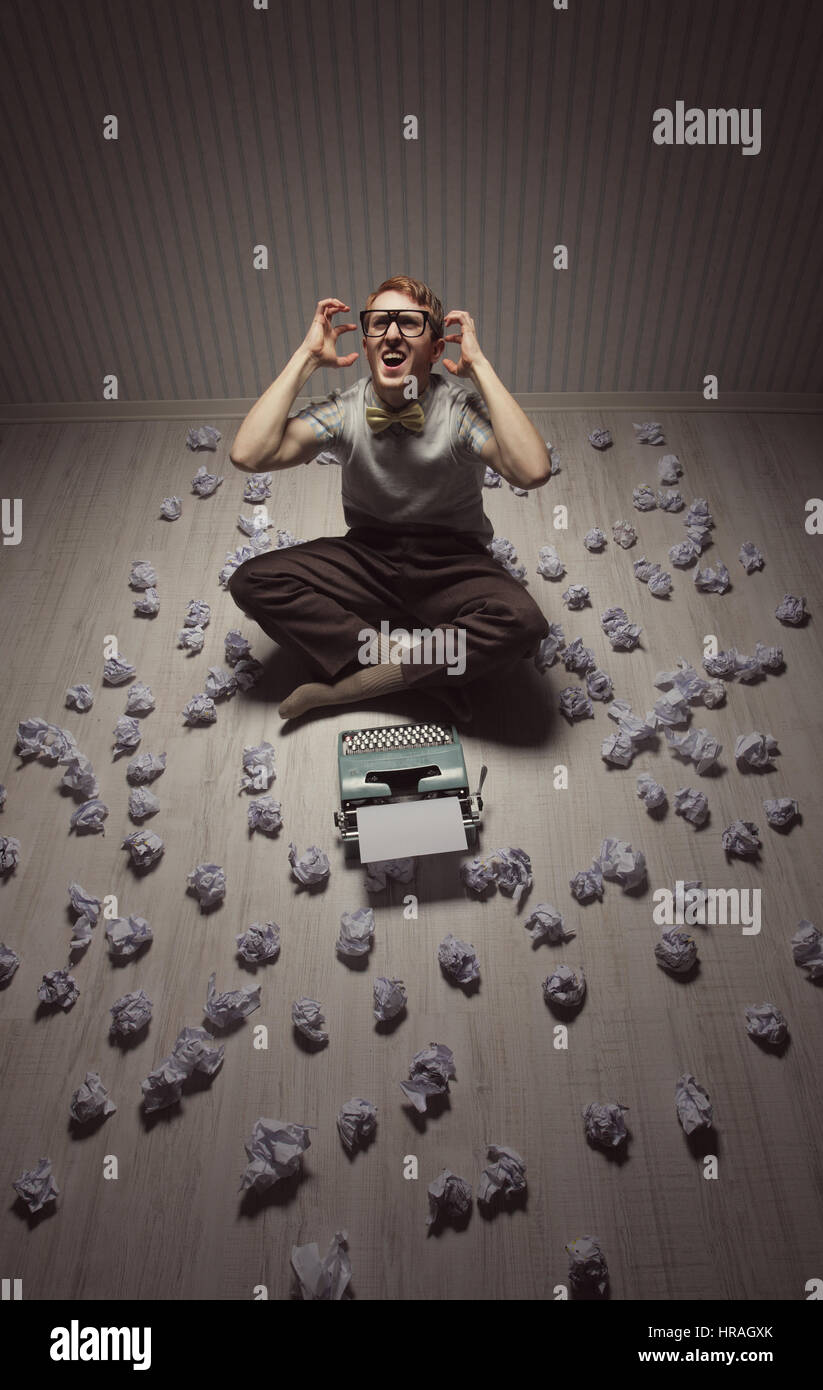 Frustrated journalist at typewriter screaming angry Stock Photo - Alamy