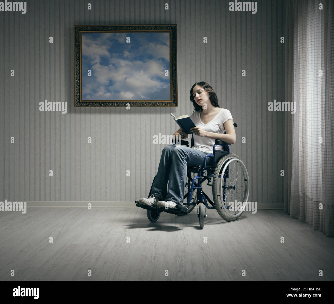 Disabled young woman reading a book in a wheelchair Stock Photo - Alamy
