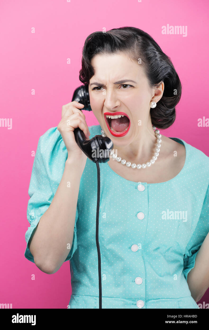 Vintage Woman shouting into telephone Stock Photo - Alamy