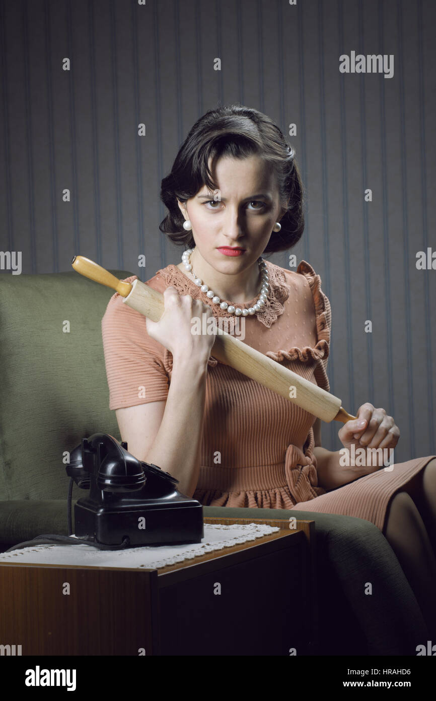 Angry wife waiting for her husband with a rolling pin in hand Stock ...