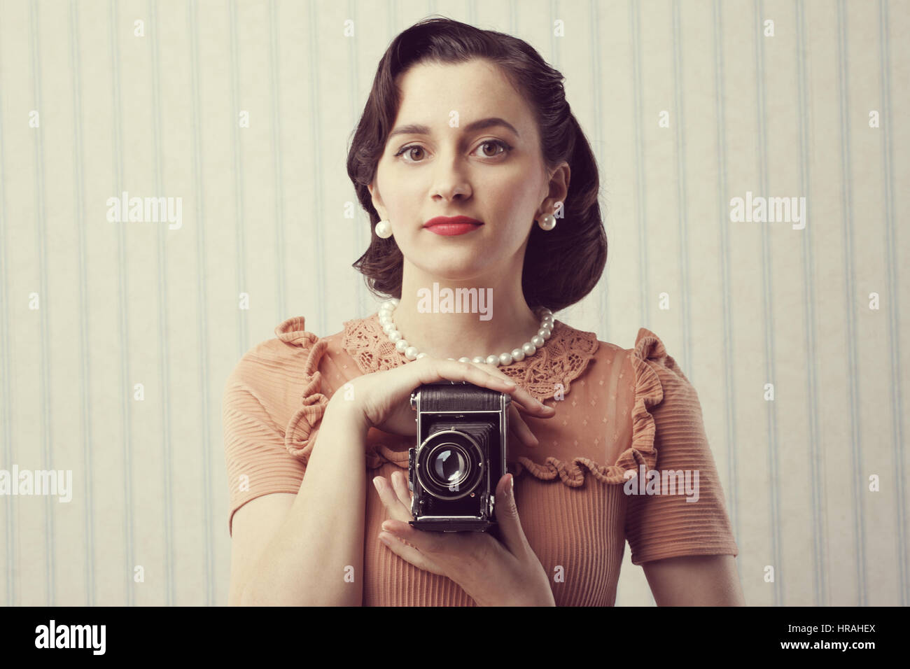 Beautiful young woman with a old camera Stock Photo - Alamy