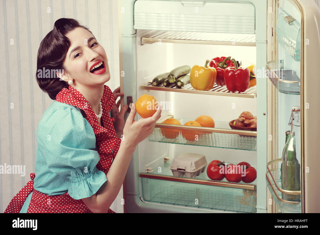 Cheerful woman posing with an open refrigerator Stock Photo - Alamy