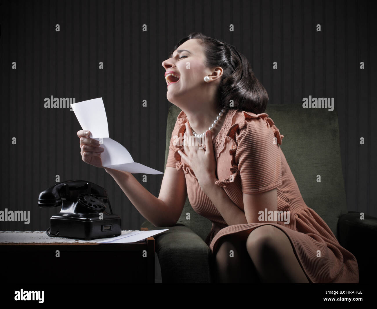 Young woman reading a letter crying desperate Stock Photo - Alamy