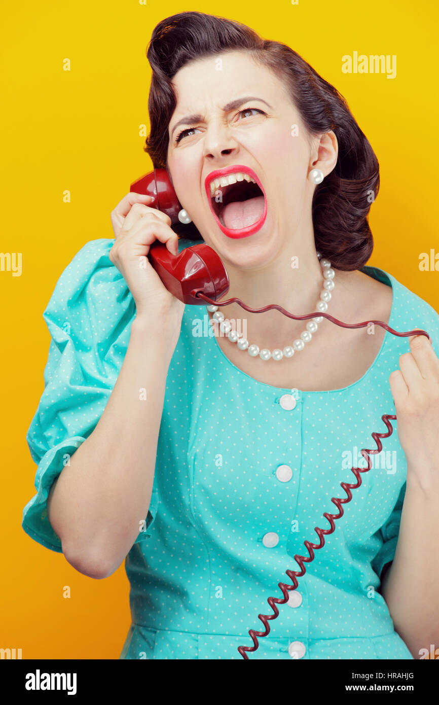 Vintage Woman shouting into telephone Stock Photo - Alamy