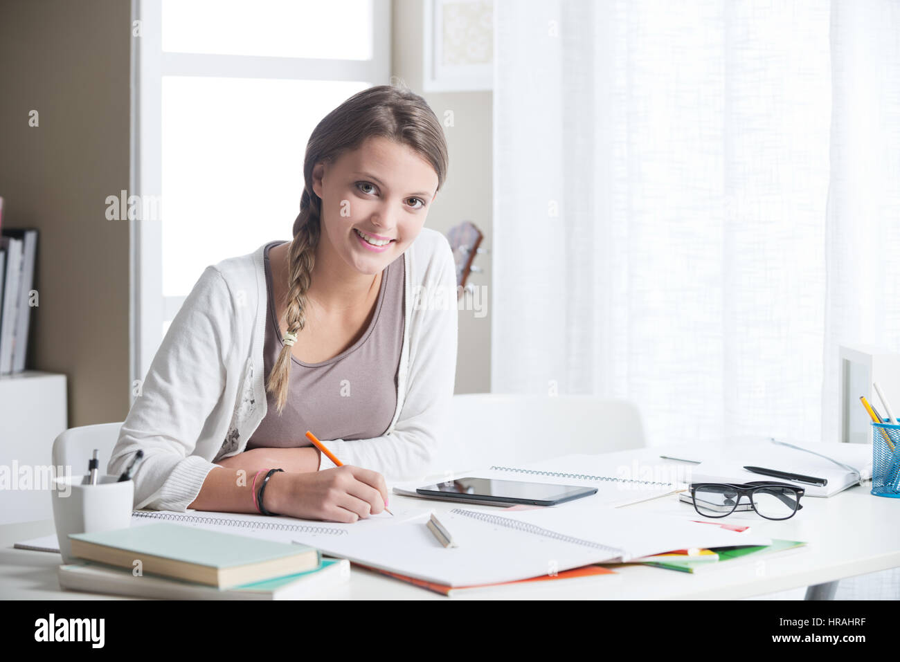 Portrait of a beautiful girl studying at home Stock Photo - Alamy