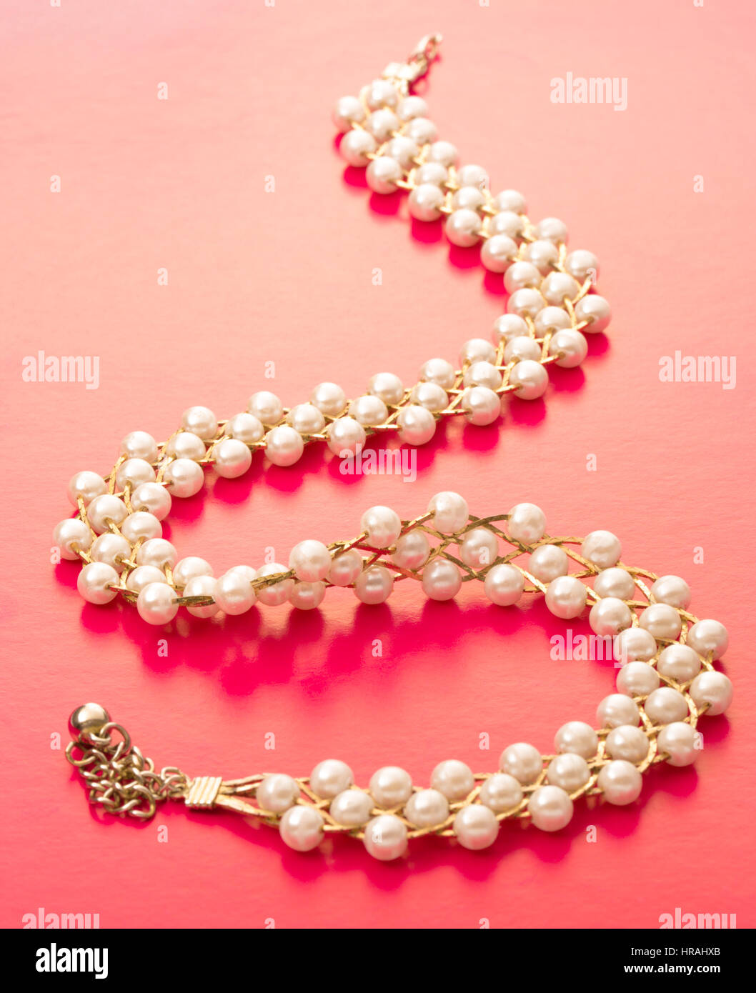 Necklace with golden chain and white beads Stock Photo - Alamy