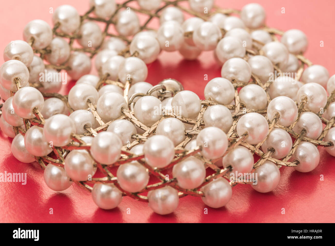 Necklace with golden chain and white beads Stock Photo - Alamy