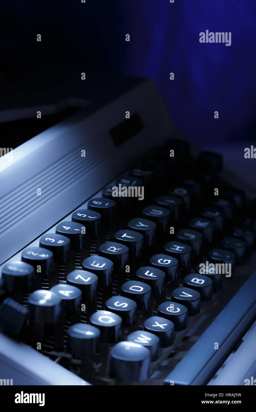 Keyboard of typewriter in blue toning Stock Photo - Alamy