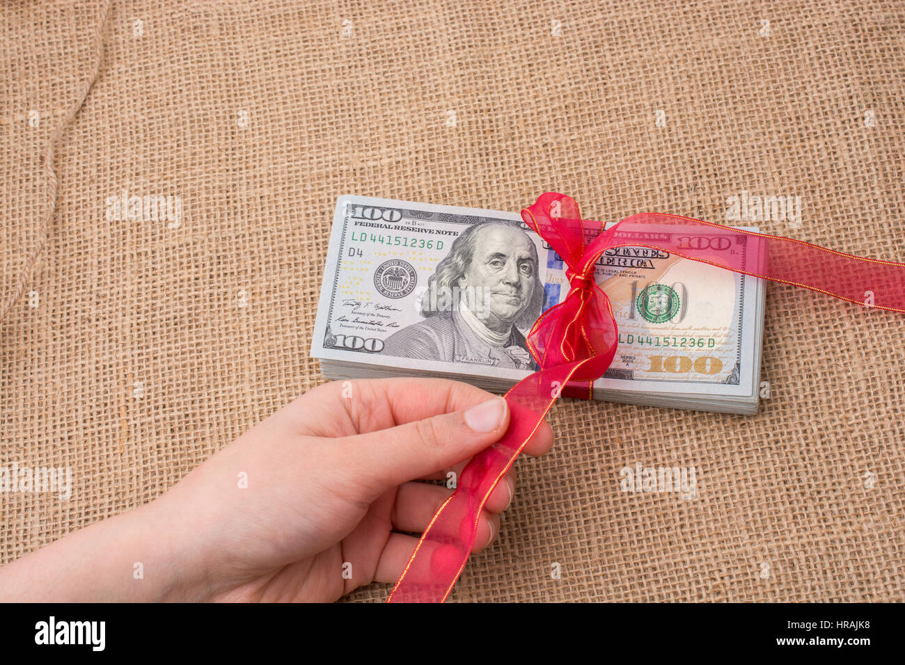 Banknote bundle of US dollar tied with colorful a ribbon Stock Photo ...