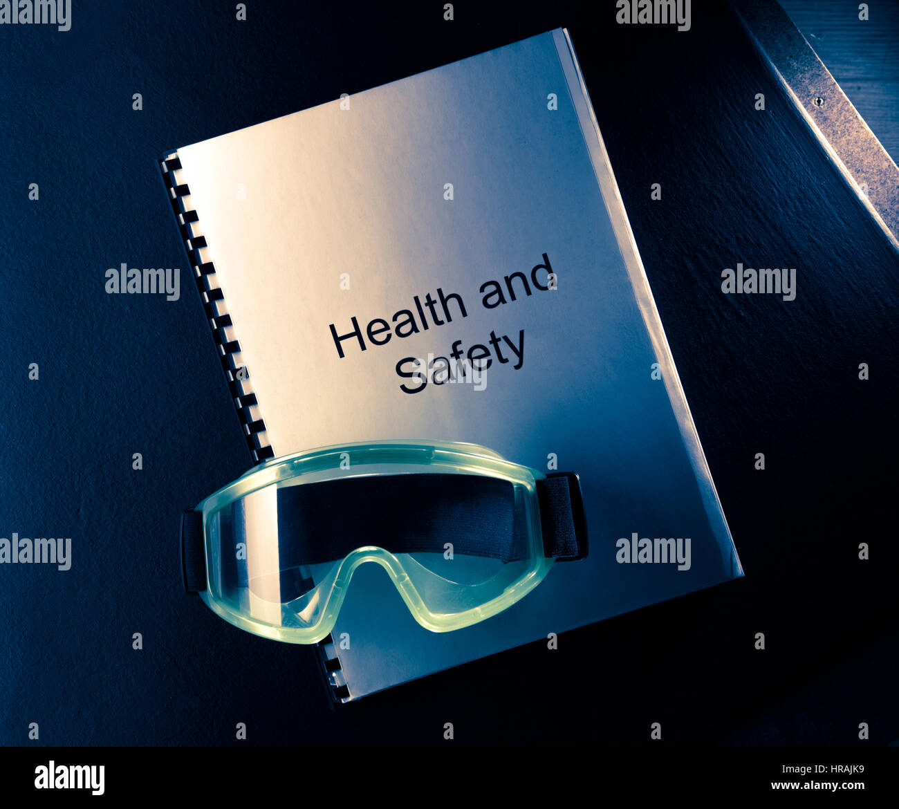 Health and safety document with goggles in toning Stock Photo - Alamy