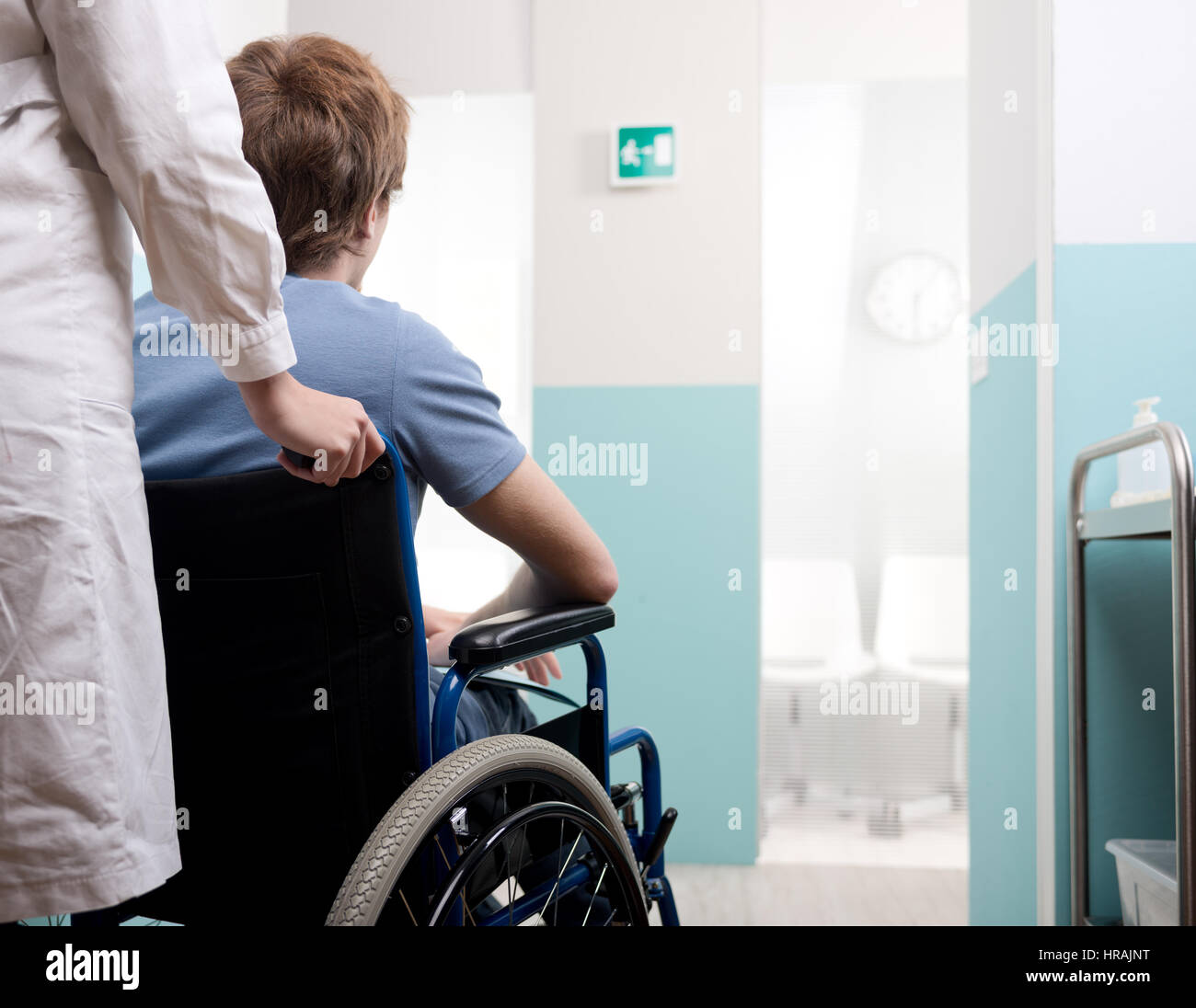 Female nurse pushing her patient on a wheelchair Stock Photo - Alamy
