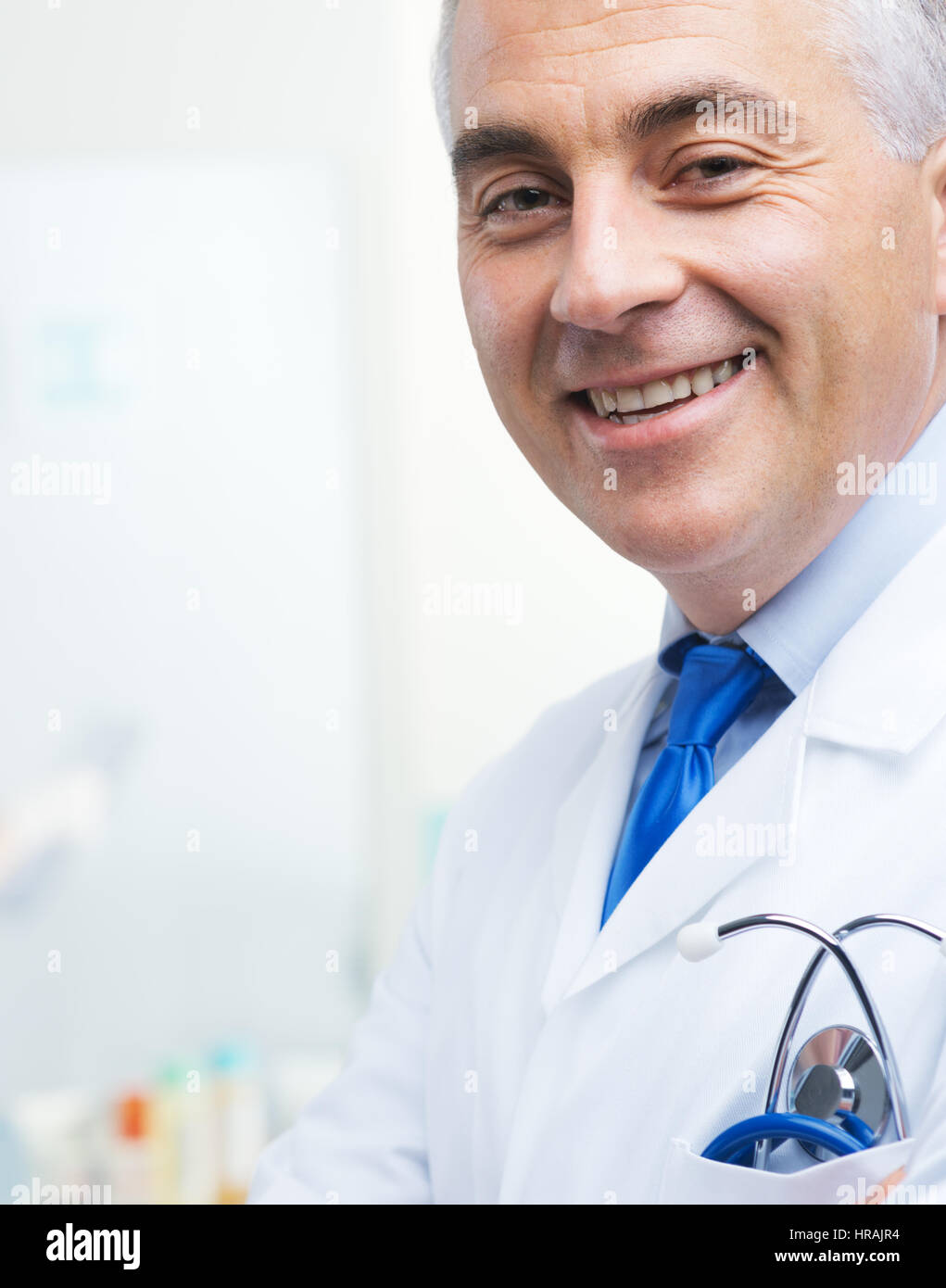Handsome friendly doctor smiling and looking at camera Stock Photo - Alamy