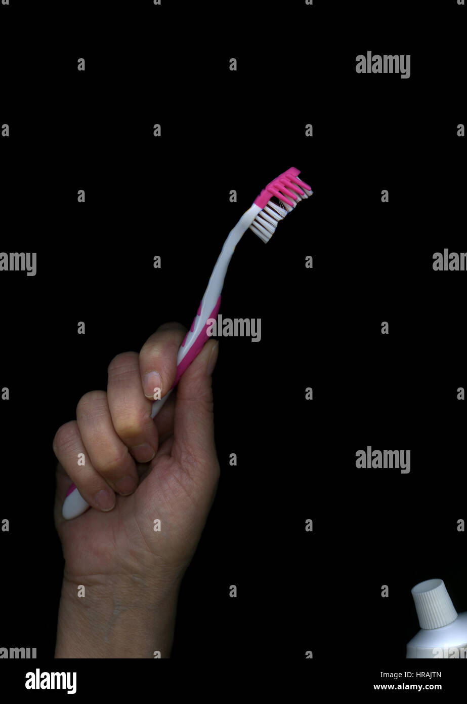 Hand holding a toothbrush Stock Photo - Alamy